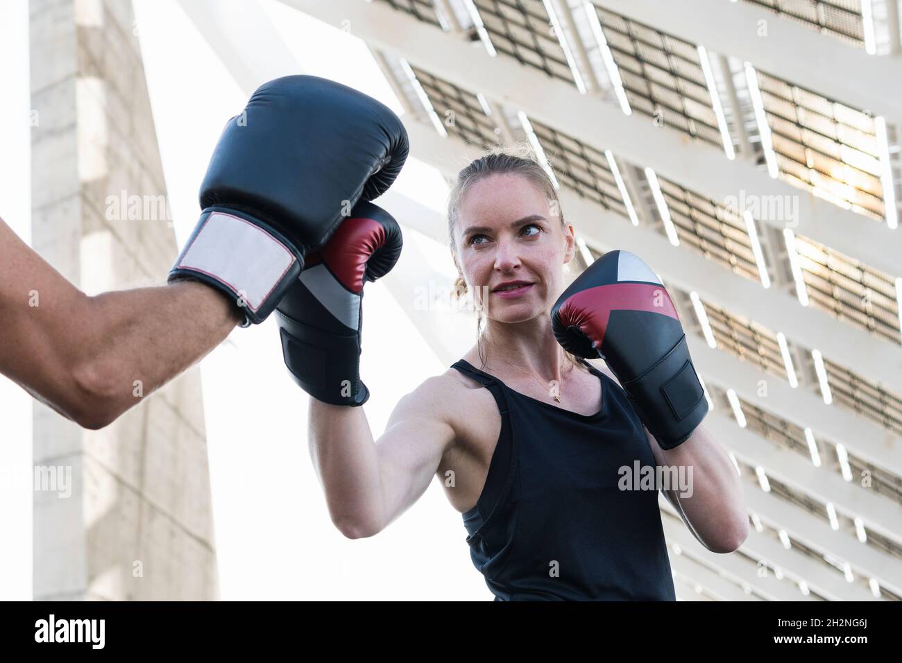 Female boxer training with fitness instructor Stock Photo - Alamy