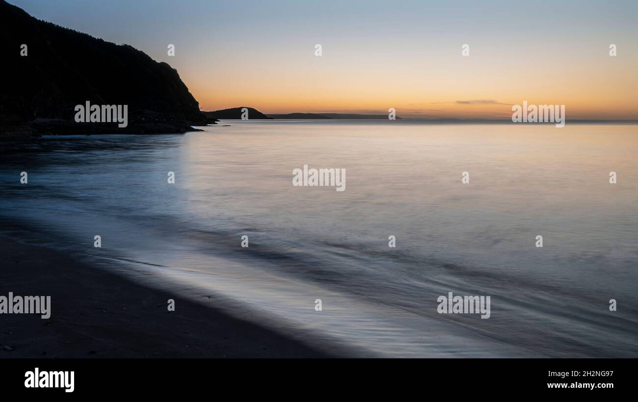 Stunning sunrise over Pentewan Sands in Cornwall with vibrant sky and ...