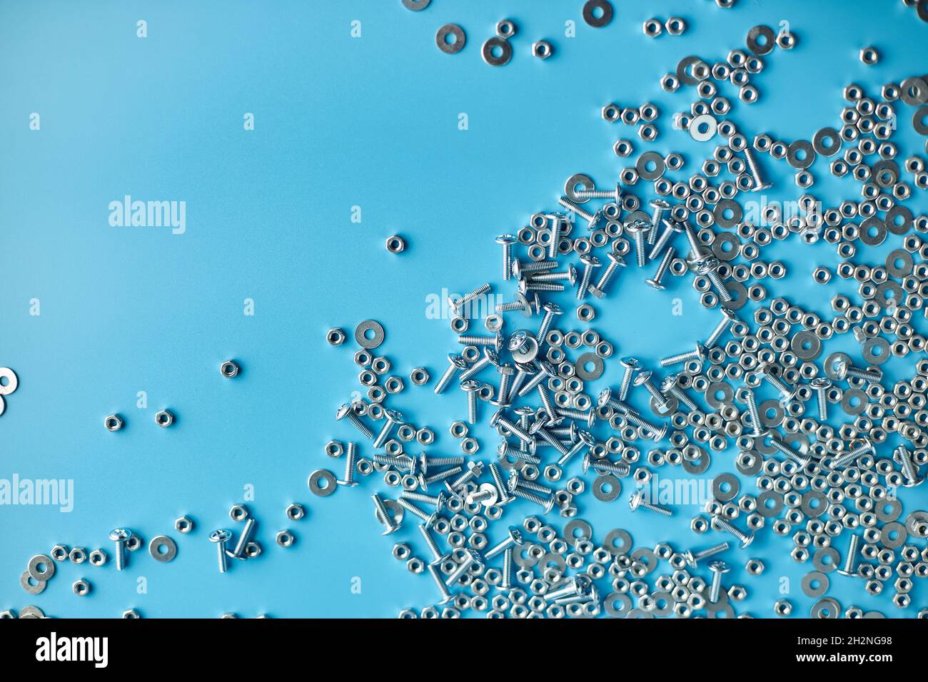 Top view, flat lay Metal screw, nuts and bolts on blue background ...