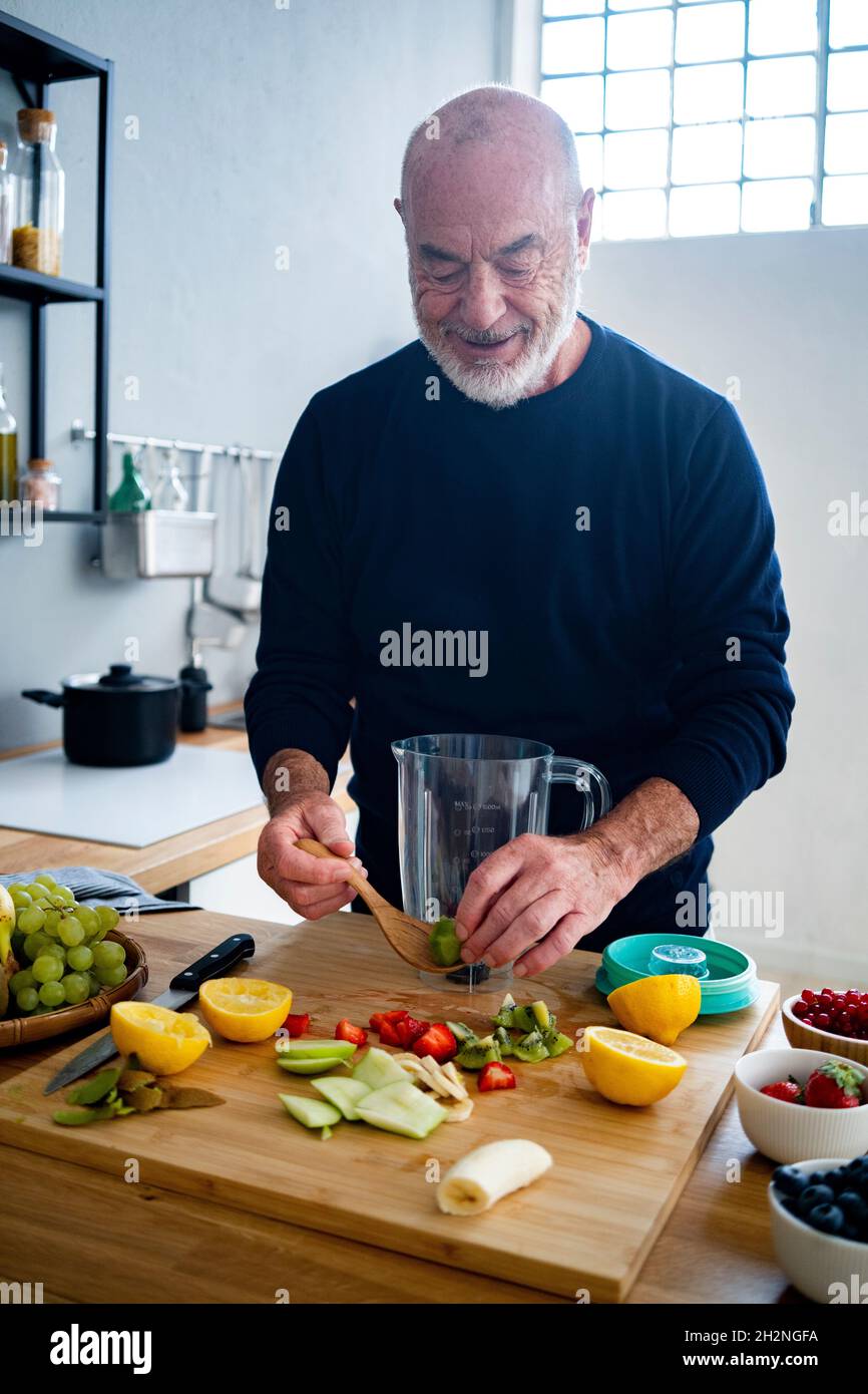 Male vlogger filming through mobile phone at kitchen counter Stock ...