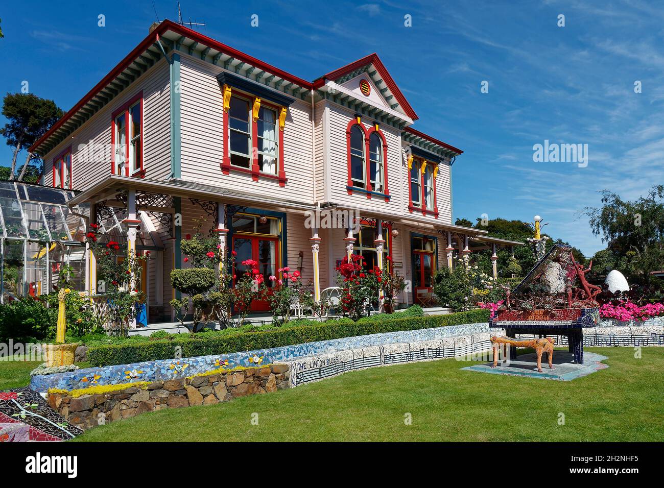 The Giants House; multicolor trim, attached greenhouse, garden; flowers ...