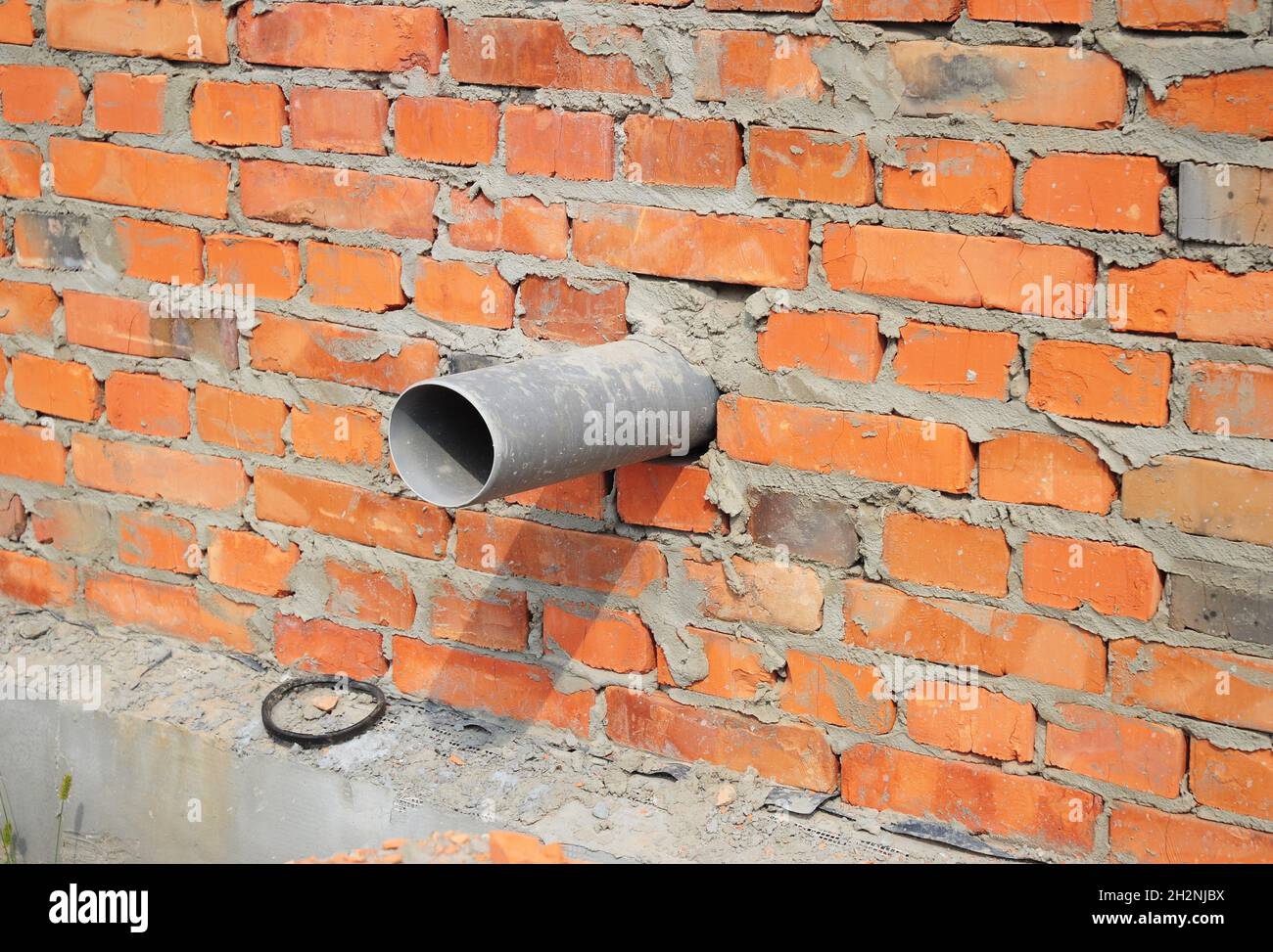 House brick wall over sewer pipe drainage system Stock Photo - Alamy