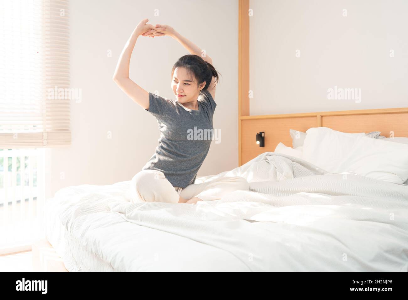 Bedroom concept in the morning the pretty girl just waking up and ...