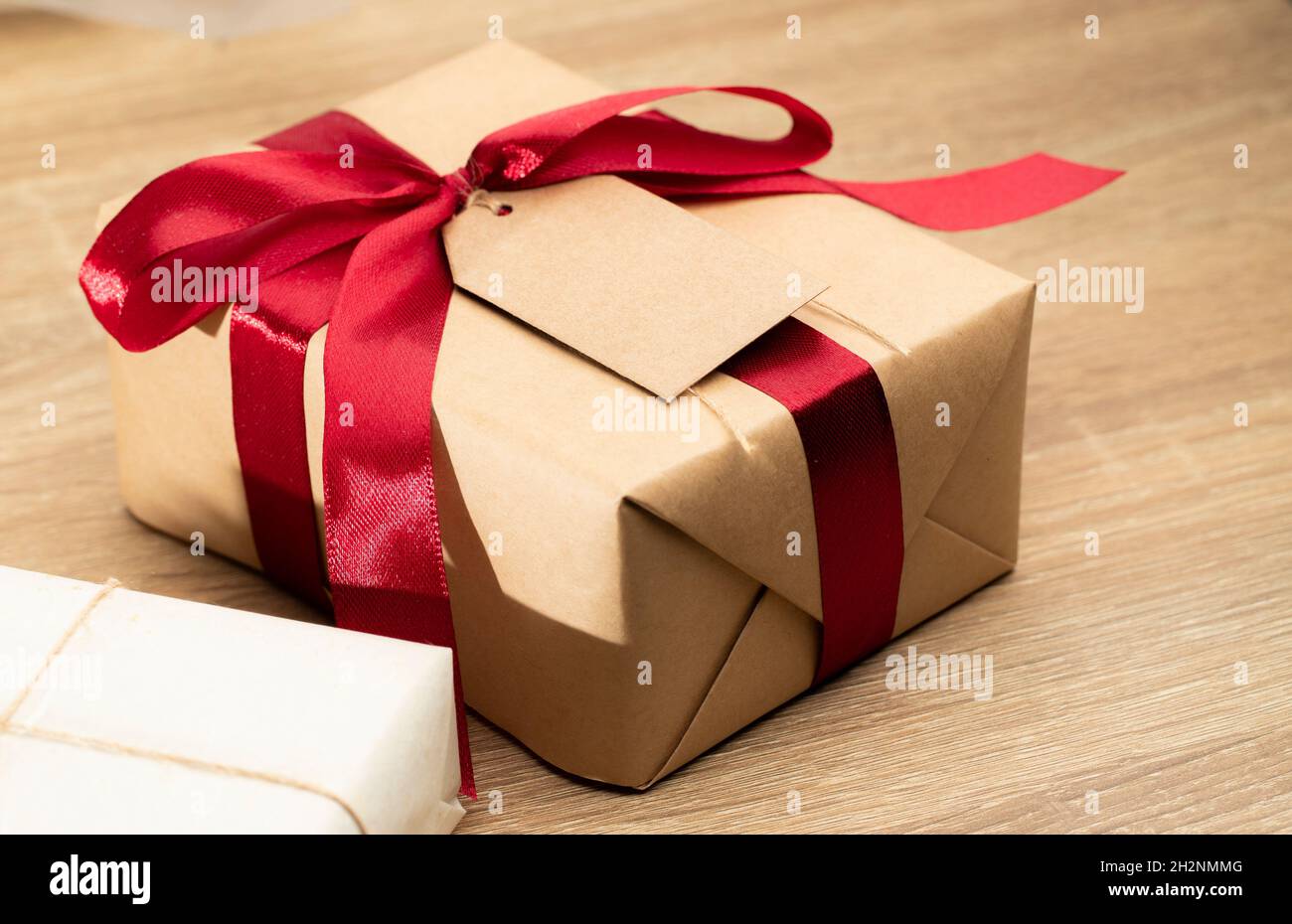 Christmas brown gift boxes and red ribbon with tag paper lay on the ...