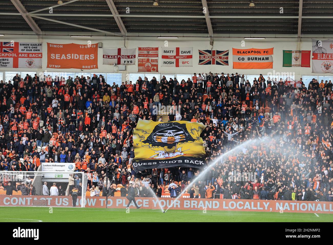 Blackpool, UK. 23rd Oct, 2021. Blackpool fans pass a huge flag over the ...
