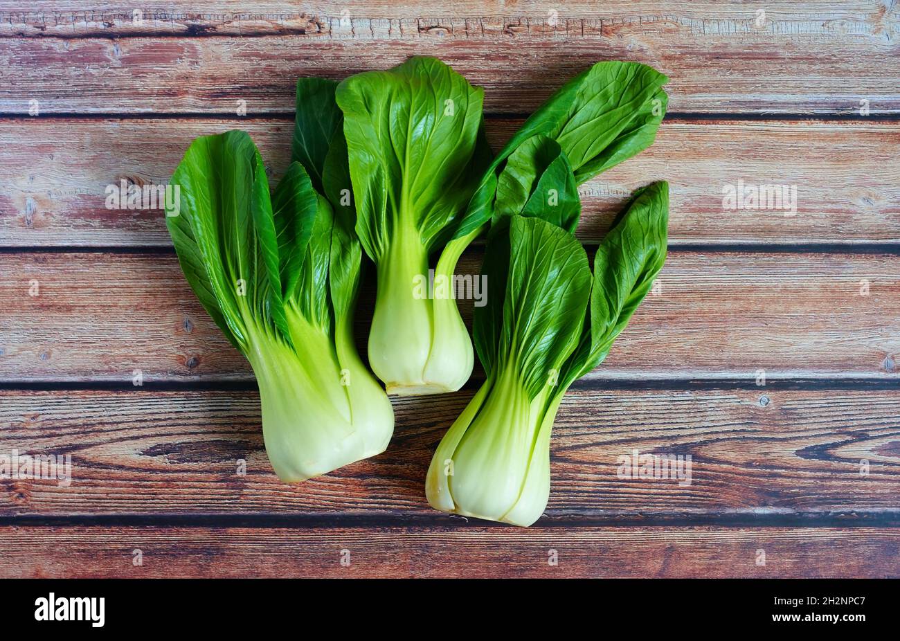 Fresh Asian "pak choi" cabbage on a wooden table Stock Photo - Alamy