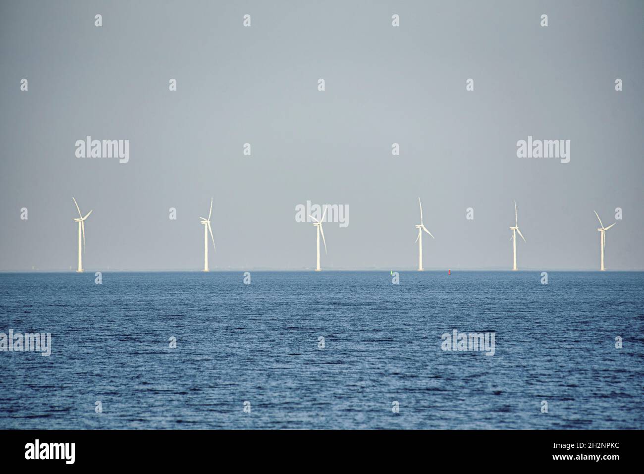Scenic view of the offshore wind turbines in the middle of the sea ...
