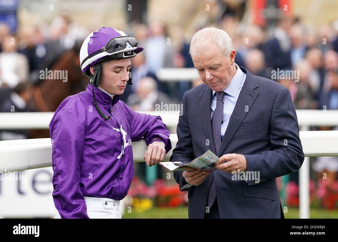Jockey Rossa Ryan speaks with trainer Karl Burke in the parade ring ...