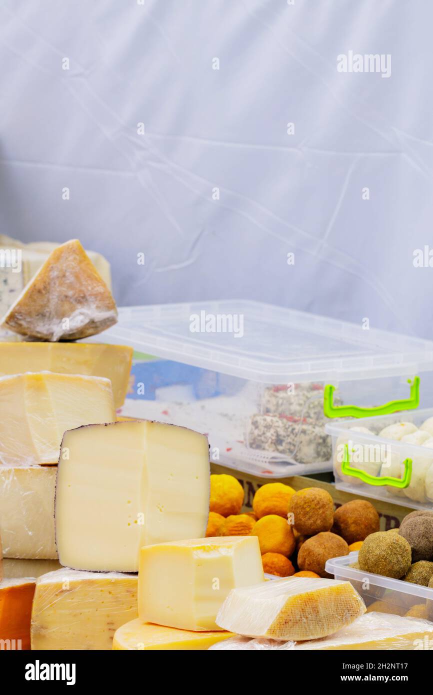 Hard goat cheese on the table. Many varieties of craft cheese are on ...