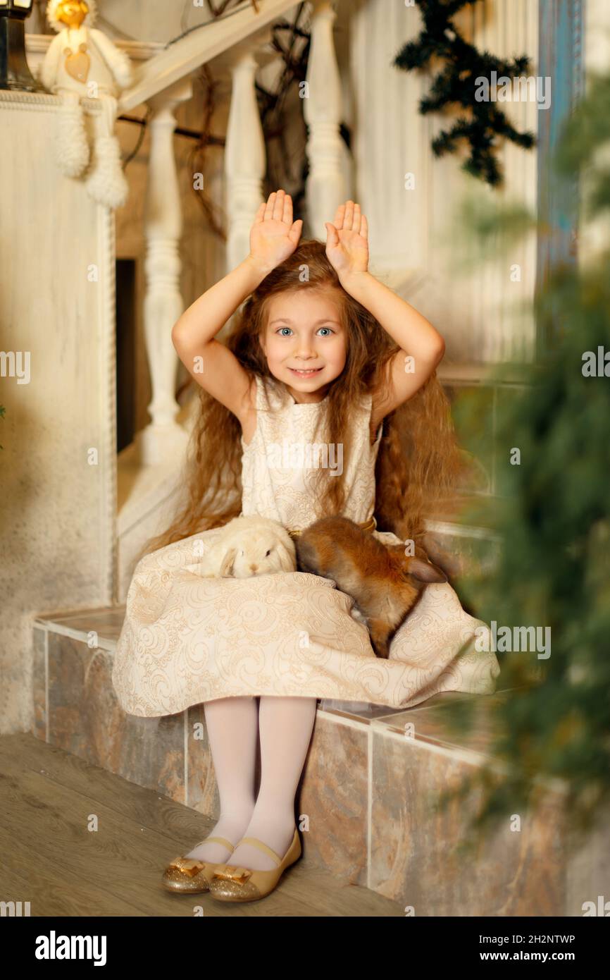 Cute little princess play like rabbit. two rabbits sits on she Stock ...