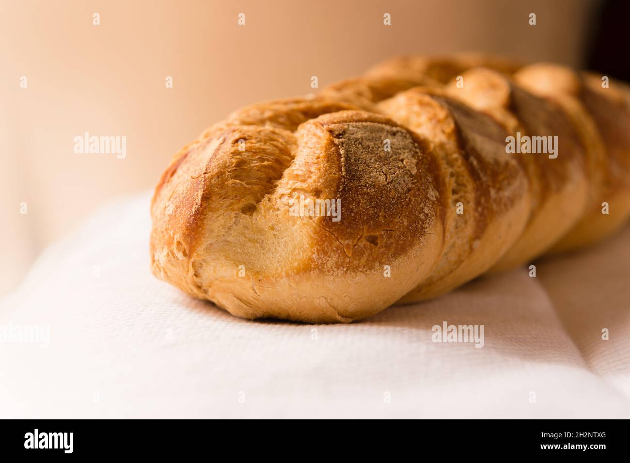 Homemade bread resting on a white cloth with natural light Stock Photo ...