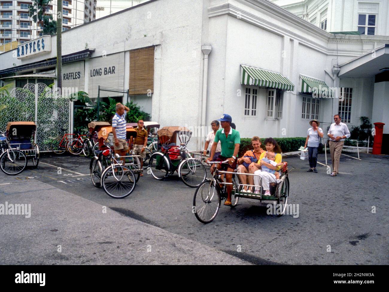 Rickshaws outside the original Raffles Hotel Long Bar in 1988 ...