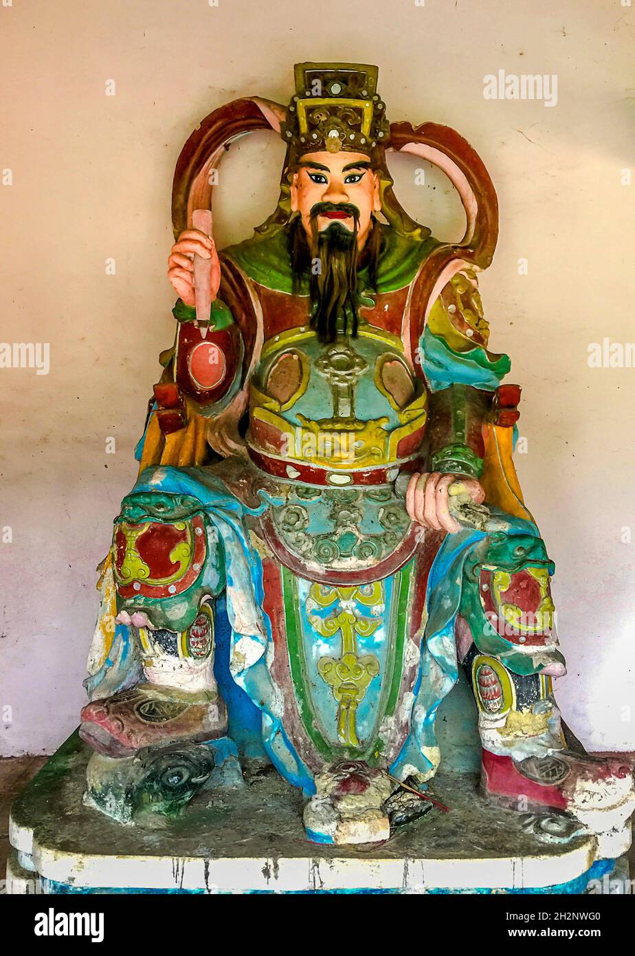 Statue of Money in Vietnam. Painted ceramic artifact in Thien Mu Pagoda ...