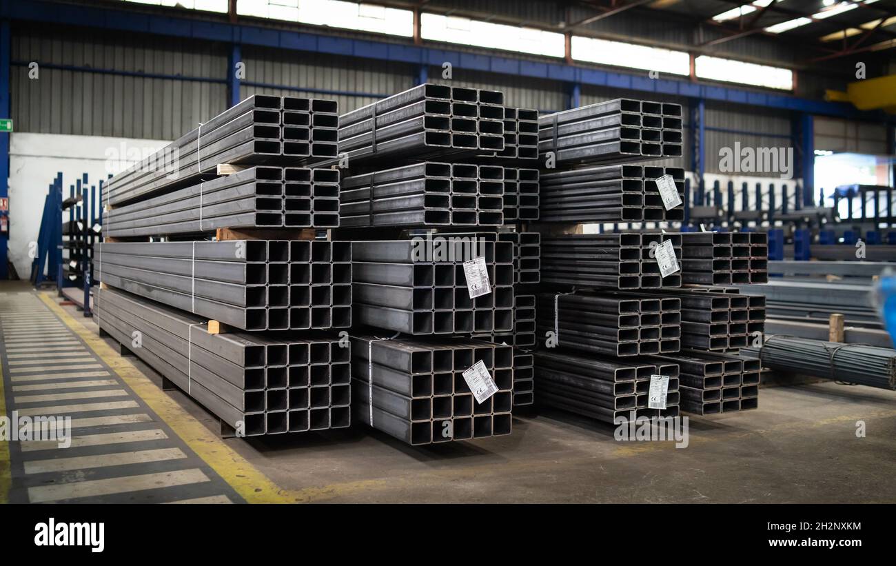 Closeup of stacke Profile Pipes in a factory Stock Photo - Alamy