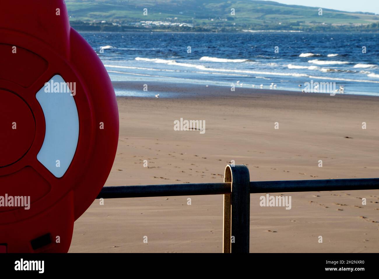 Red lifebelt casing and handrail on a coastal jetty Stock Photo - Alamy