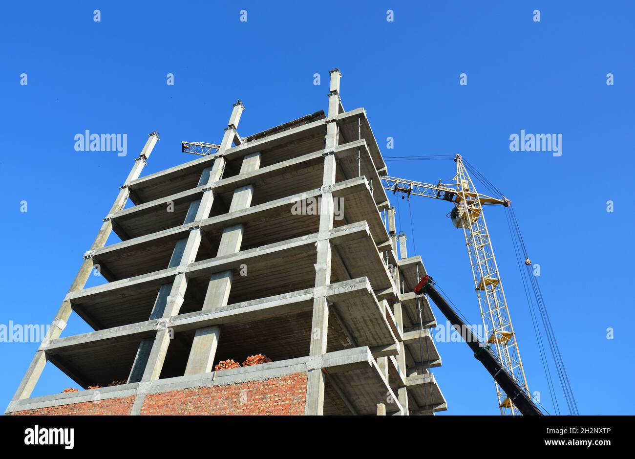 Building under Construction Site. Building a House. Crane and building ...