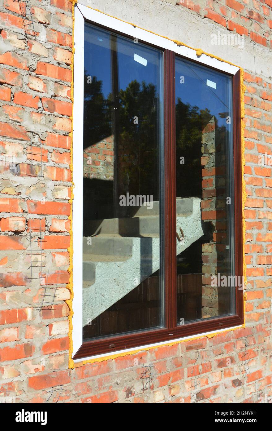 Plastic window insulation with spray foam insulation on construction ...