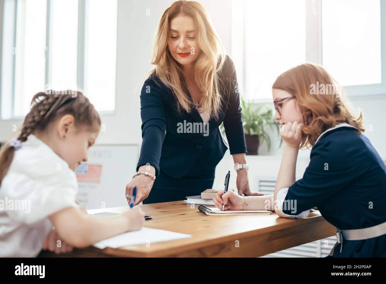 Female teacher pupils school lesson in classroom Stock Photo - Alamy