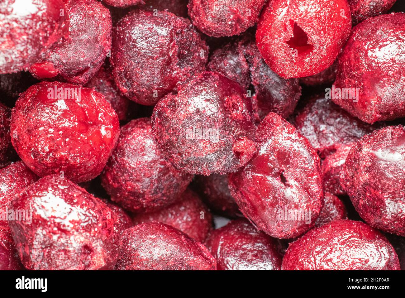 Several sweet organic pitted frozen red cherries, close-up, top view ...