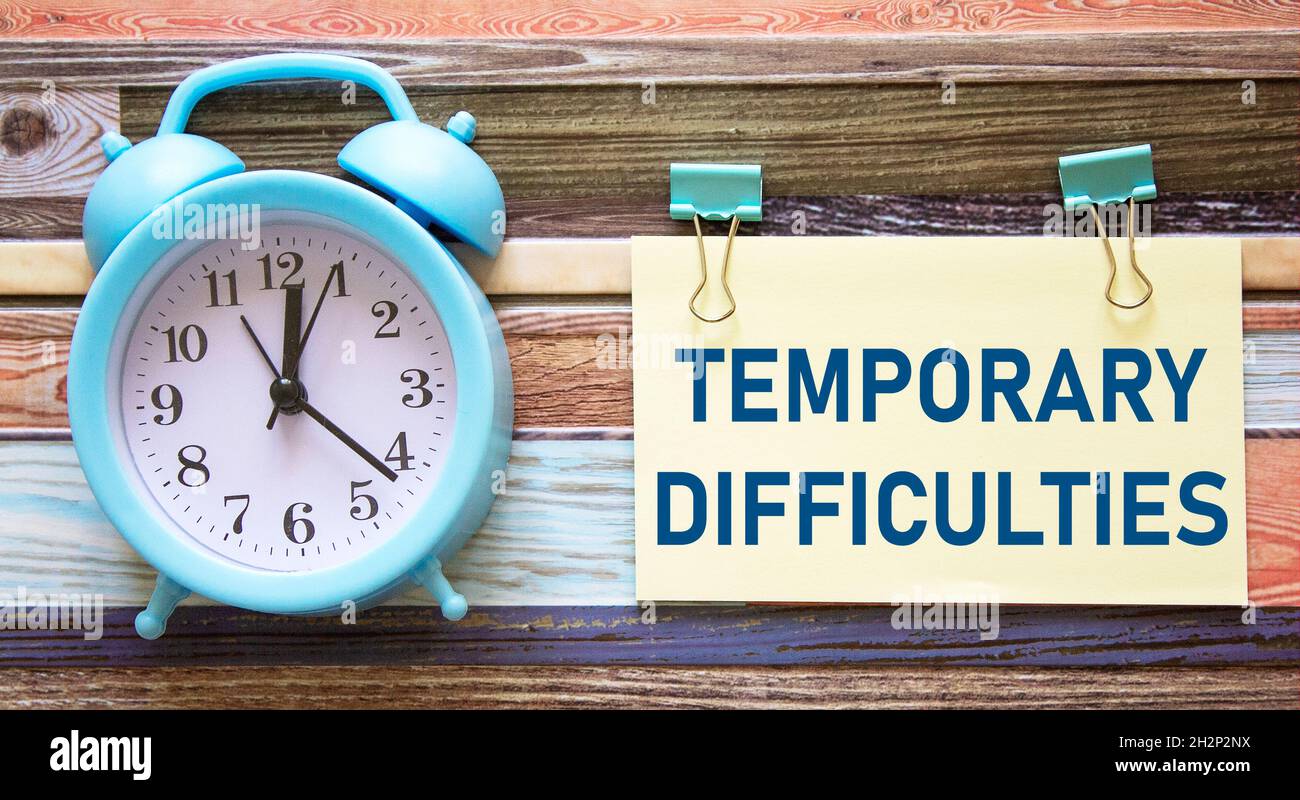 text TEMPORARY CHALLENGES written on a warning sticker on a striped ...