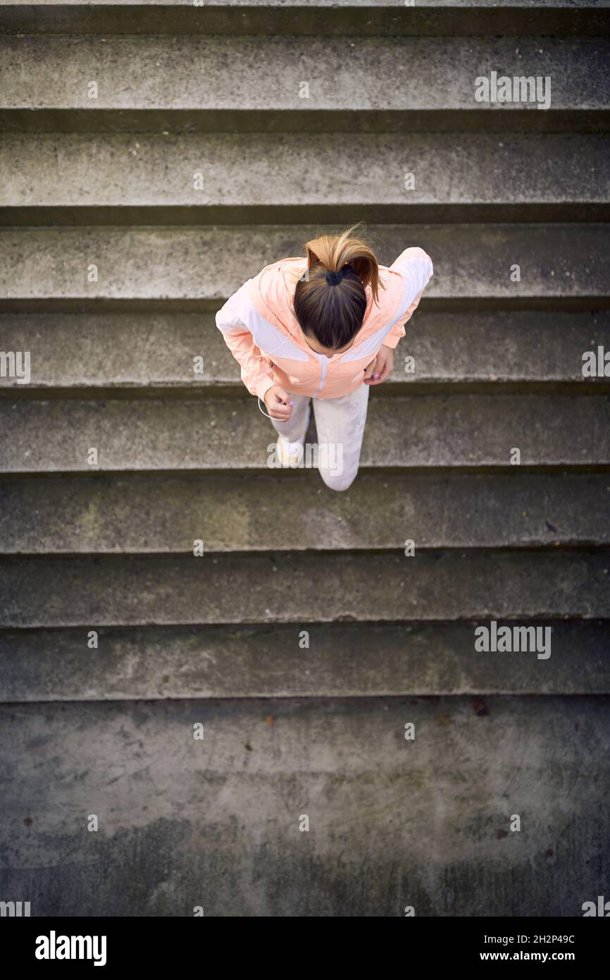 Woman running down stairs from above hi-res stock photography and ...