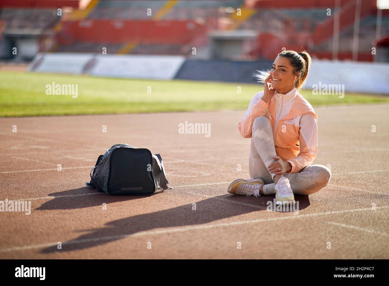 Young caucasian female athlete training for the race at the stadium ...