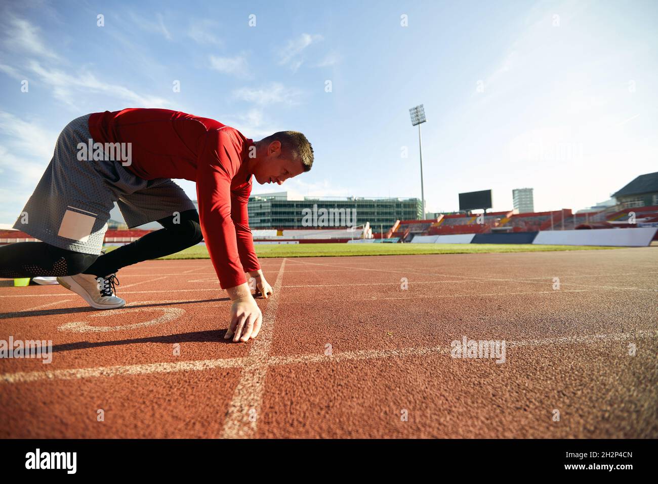 image of young adult caucasian male athlete in low start position at ...
