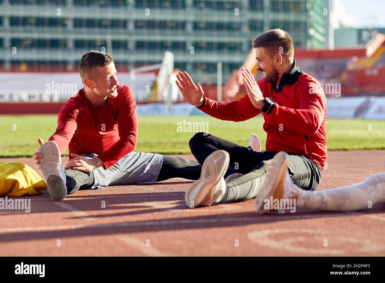 Group of athletes stretching together at the practice Stock Photo - Alamy