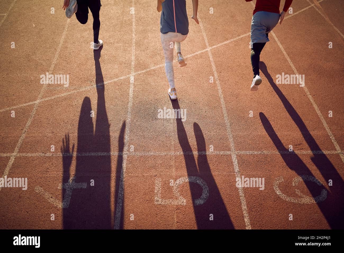 group of runners racing on running track. competing concept Stock Photo ...