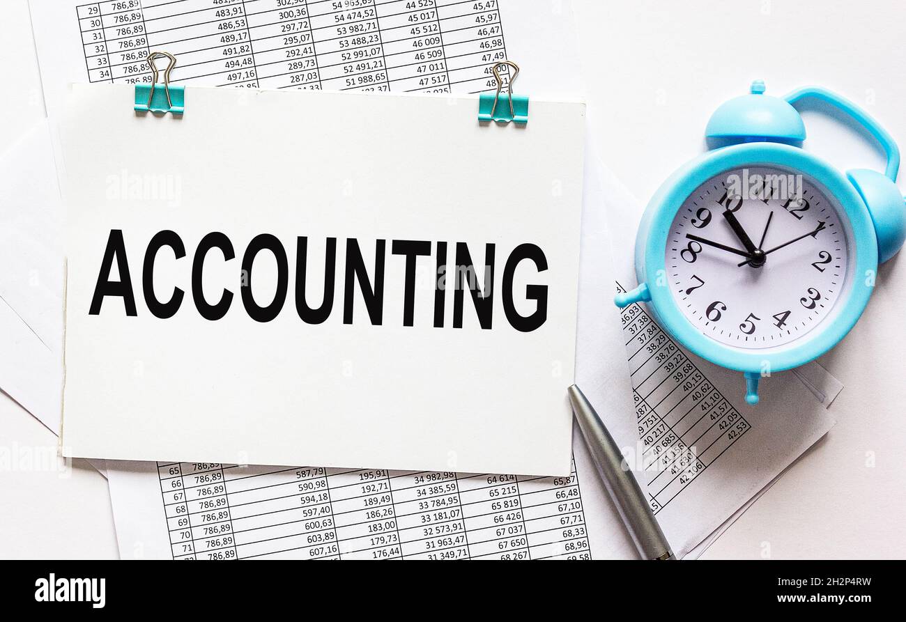 Accounting, the word is written on a notebook that lies on papers with ...