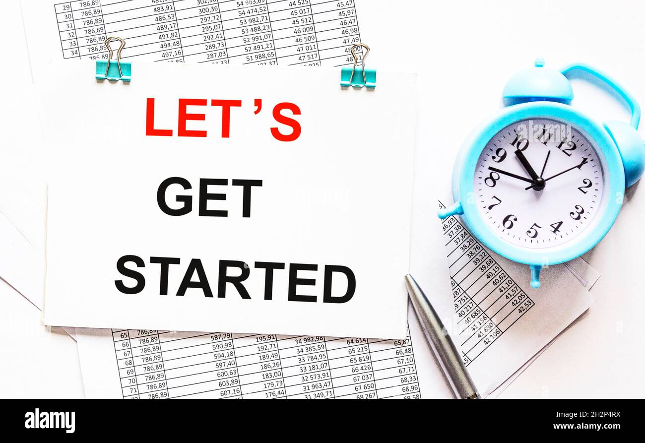 Notepad with the text Let's start, isolated on papers with numbers ...