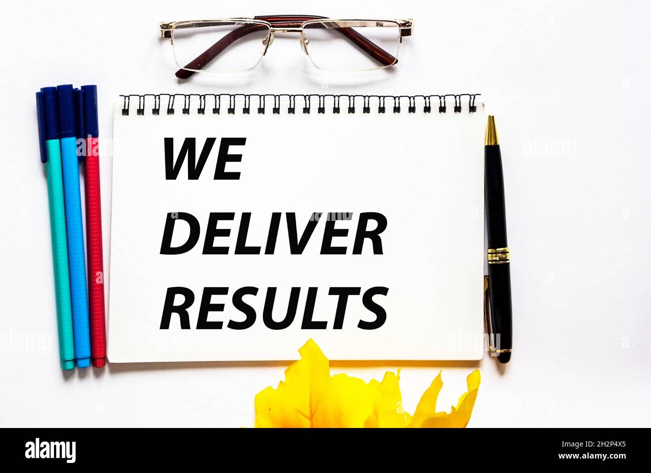 A piece of paper with the text We Deliver Results in the middle on a ...