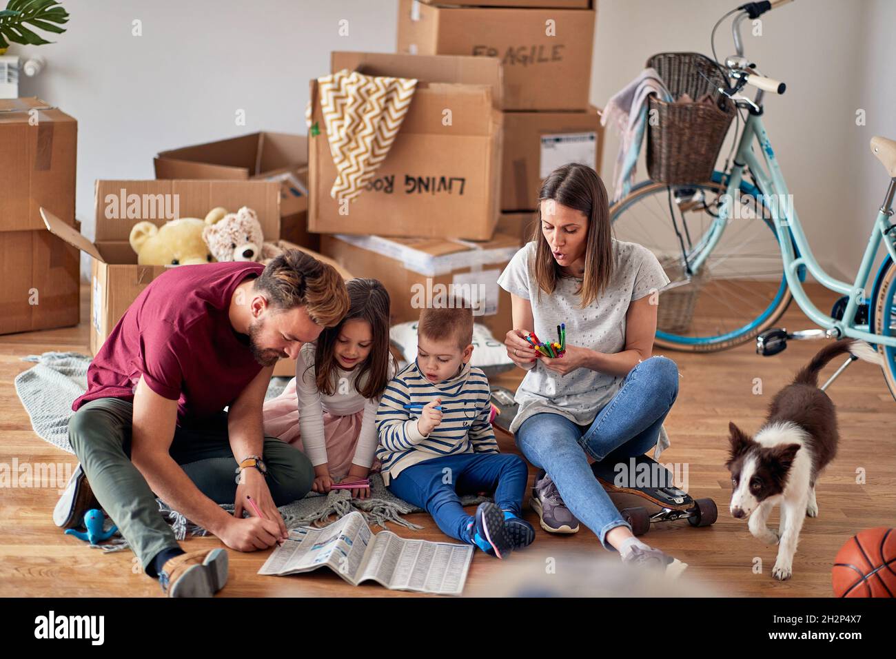 Caucasian family with two childern and a dog moving out to a new home ...