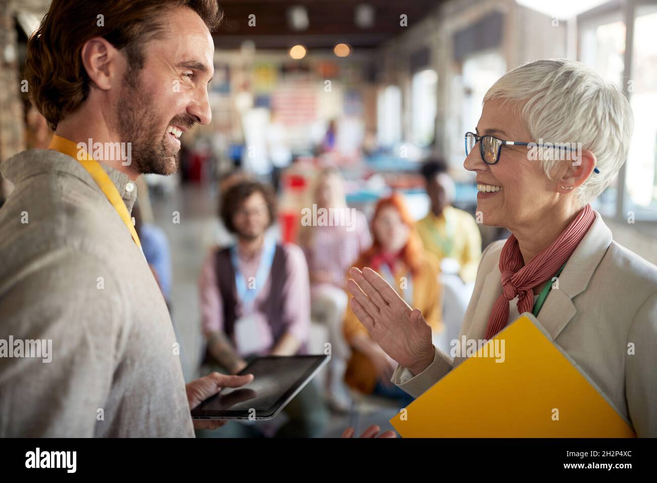 Senior colleagues doing presentation for younger colleagues at the ...