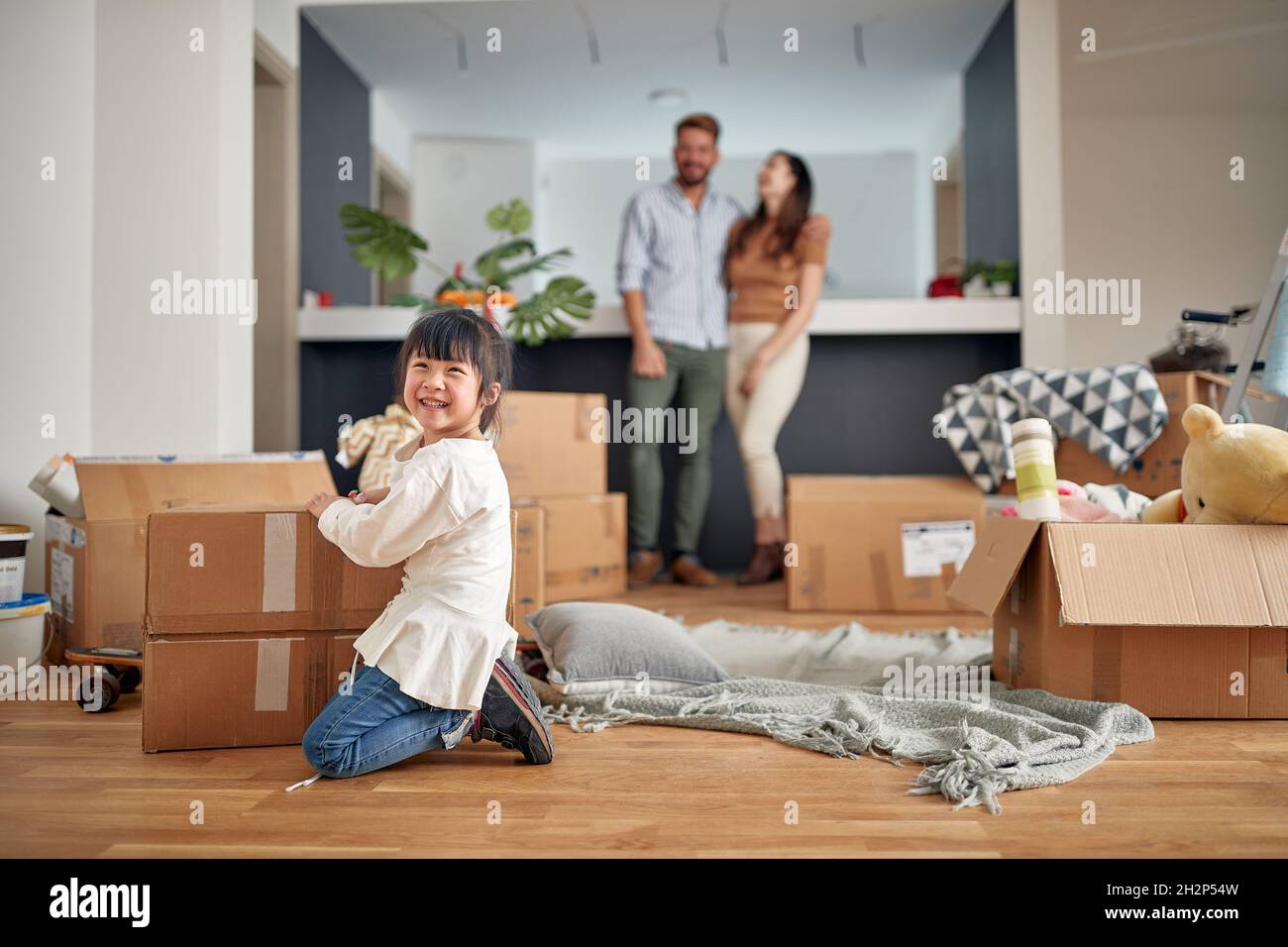 Smiling girl move to new apartment and unpack boxes with mother and ...