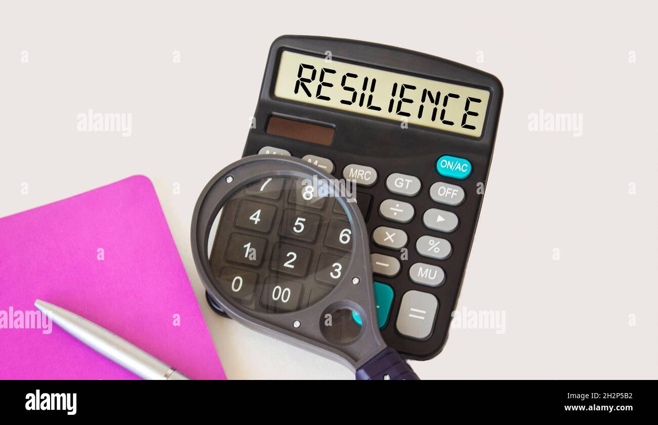 Resilience, text written on a calculator, next to a notepad, a ...