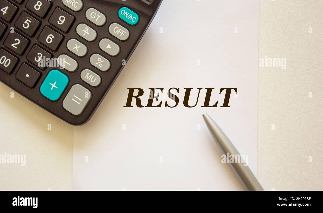 On a white background calculator, pen and text Result. Business concept ...