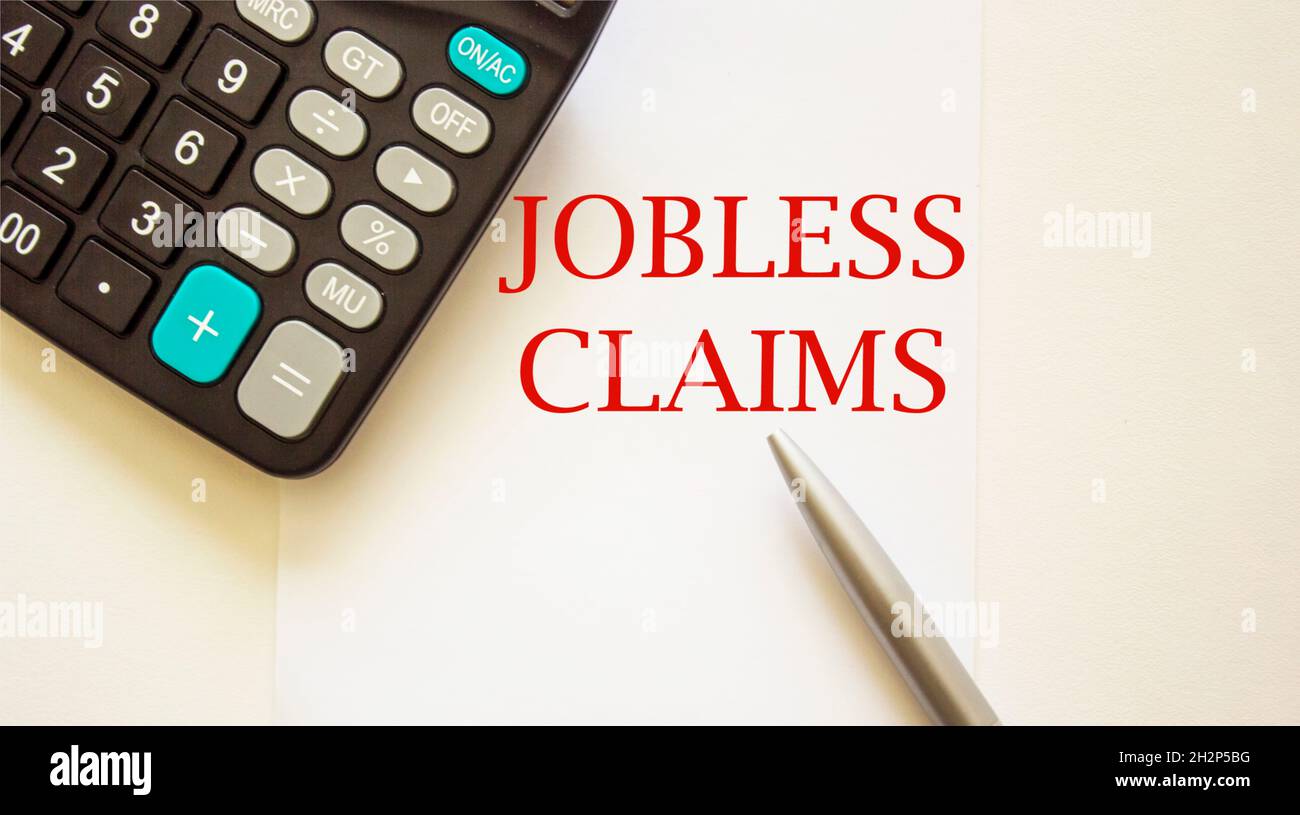 Jobless Claims , form on white background with calculator and pen and ...