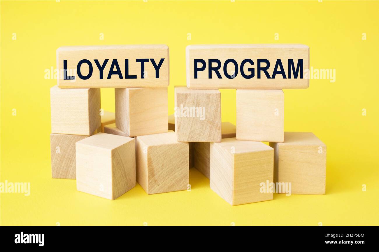 Loyalty program text on wooden blocks and on yellow table Stock Photo ...
