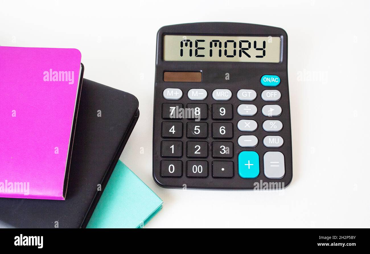 Text on a memory calculator, colorful notebooks on a white background ...