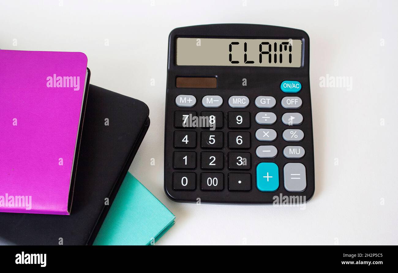 Claim text calculator and colored notepads on white background Stock ...