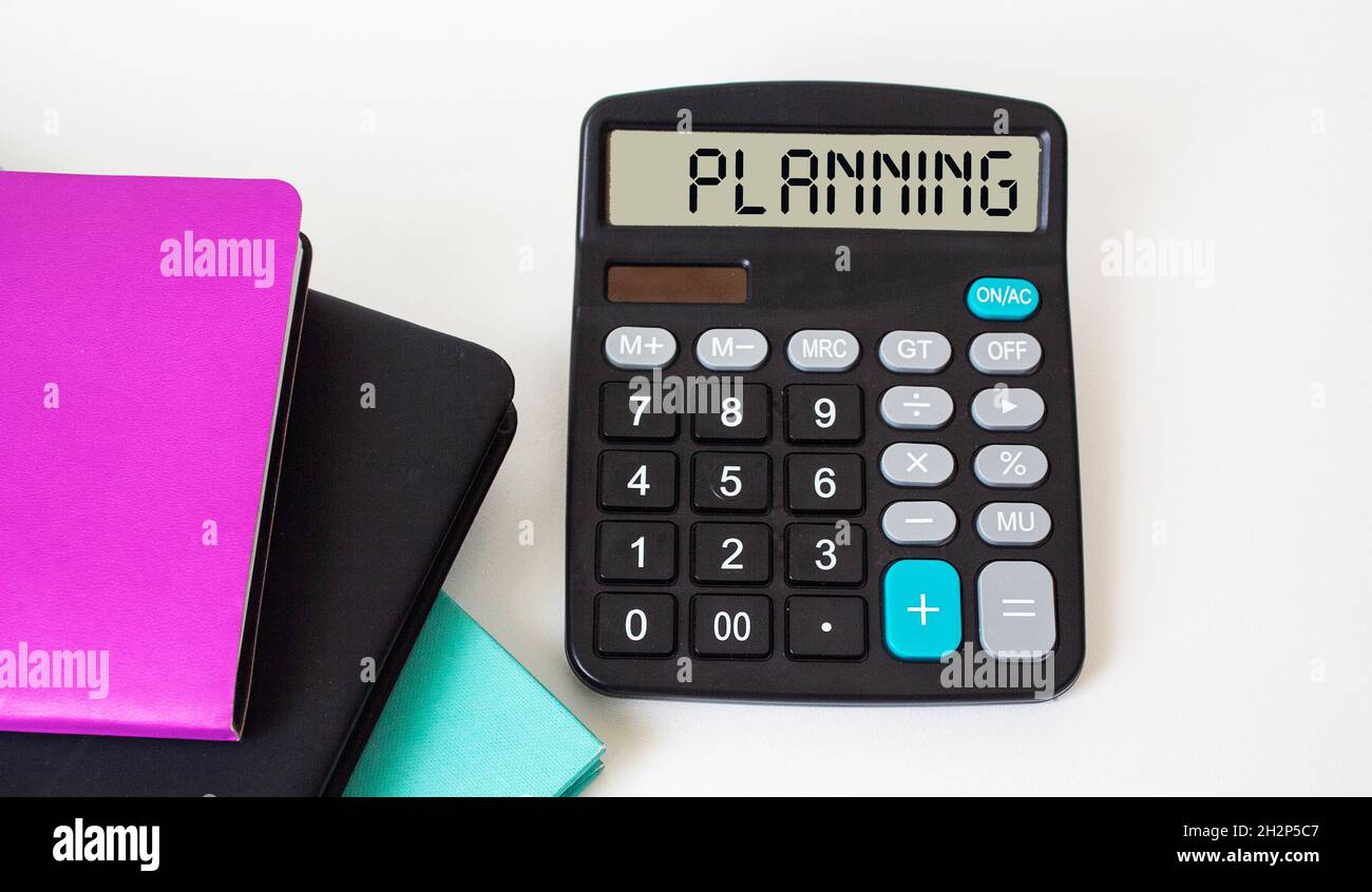 The calculator displays the text Planning, next to colored notebooks ...