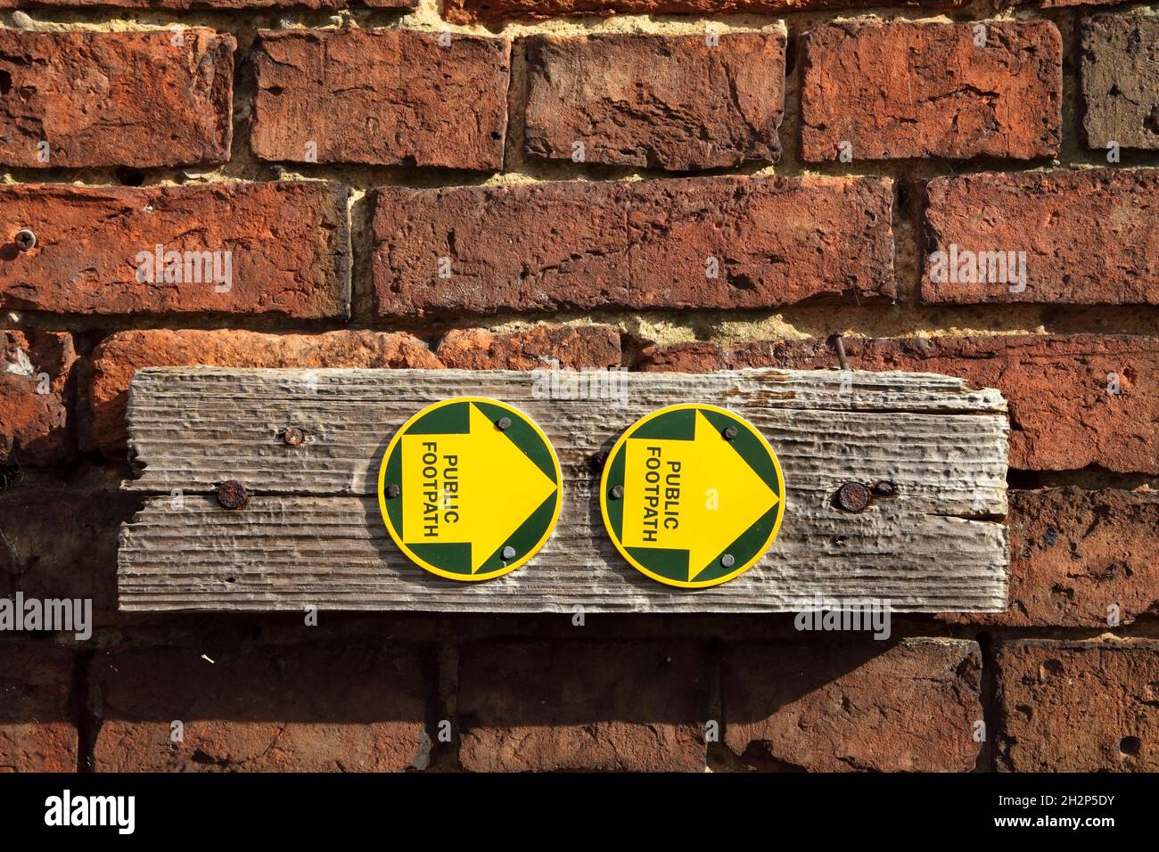 Public Footpath signs on brick wall Stock Photo - Alamy