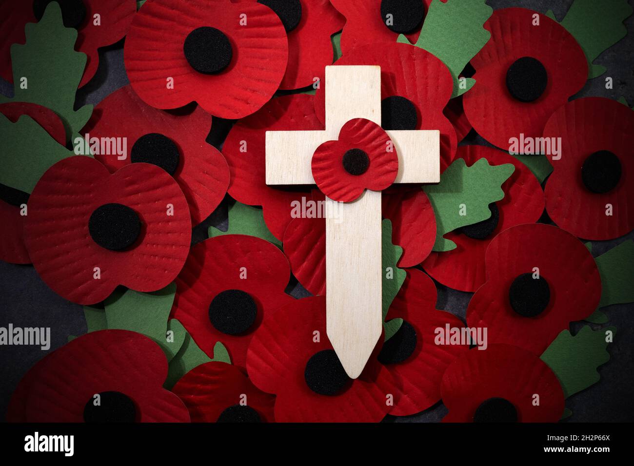 Remembrance Day poppy symbol on wooden cross. 11th November is a ...