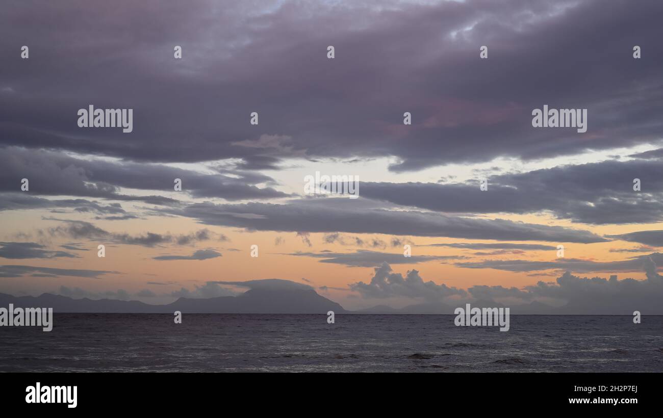 Cumulus sunset clouds, sun setting down after rainy day Stock Photo - Alamy