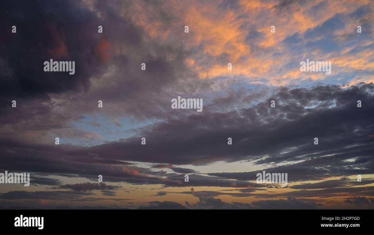 Cumulus sunset clouds, sun setting down after rainy day Stock Photo - Alamy