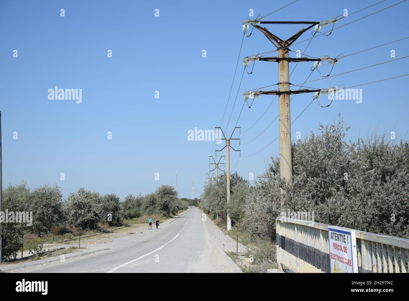 Electric poles connecting with each other against a blue sky on a sunny ...