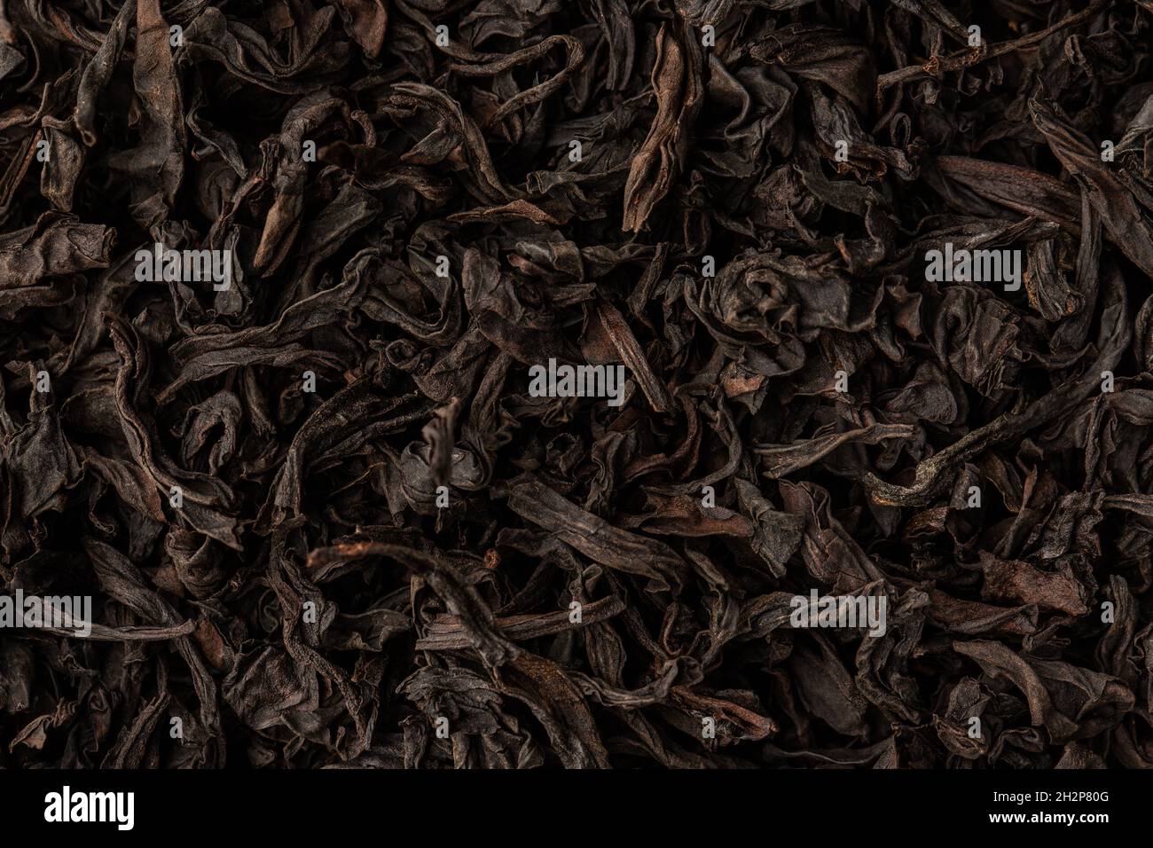 Heap of dry tea leaves. Dried black tea. Textured background of dried ...
