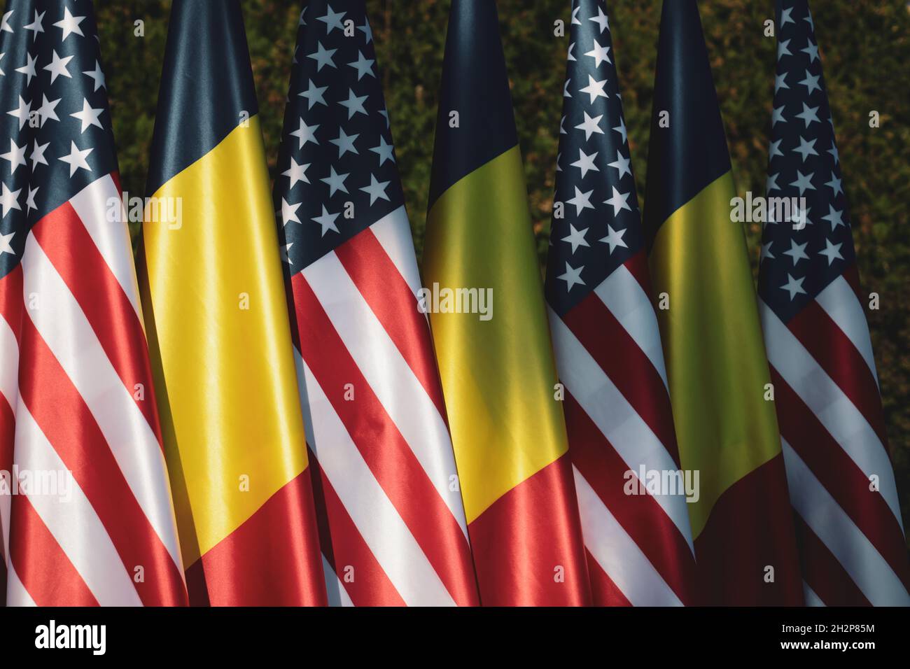United States and Romanian flags on poles one next to another Stock ...