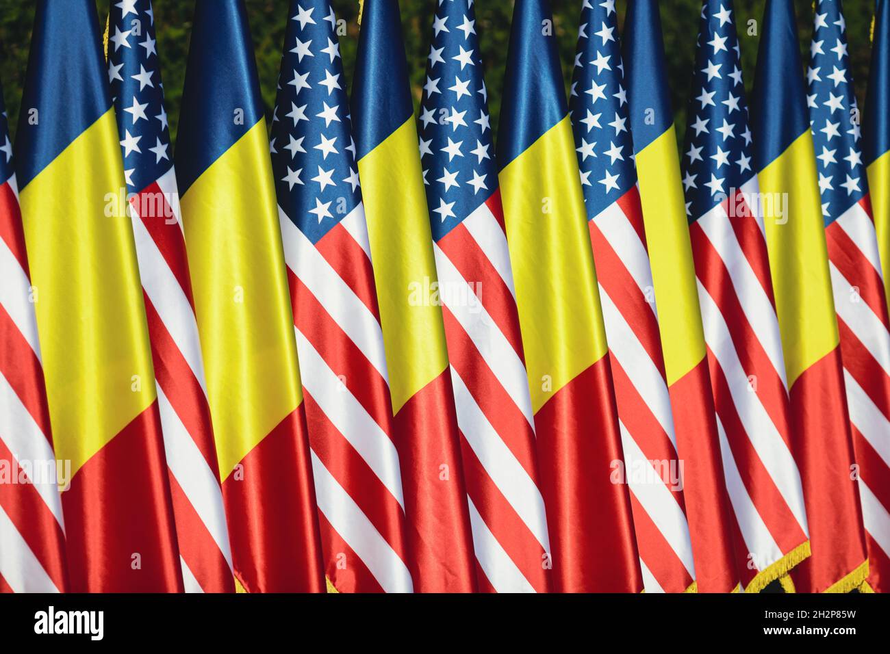 United States and Romanian flags on poles one next to another Stock ...